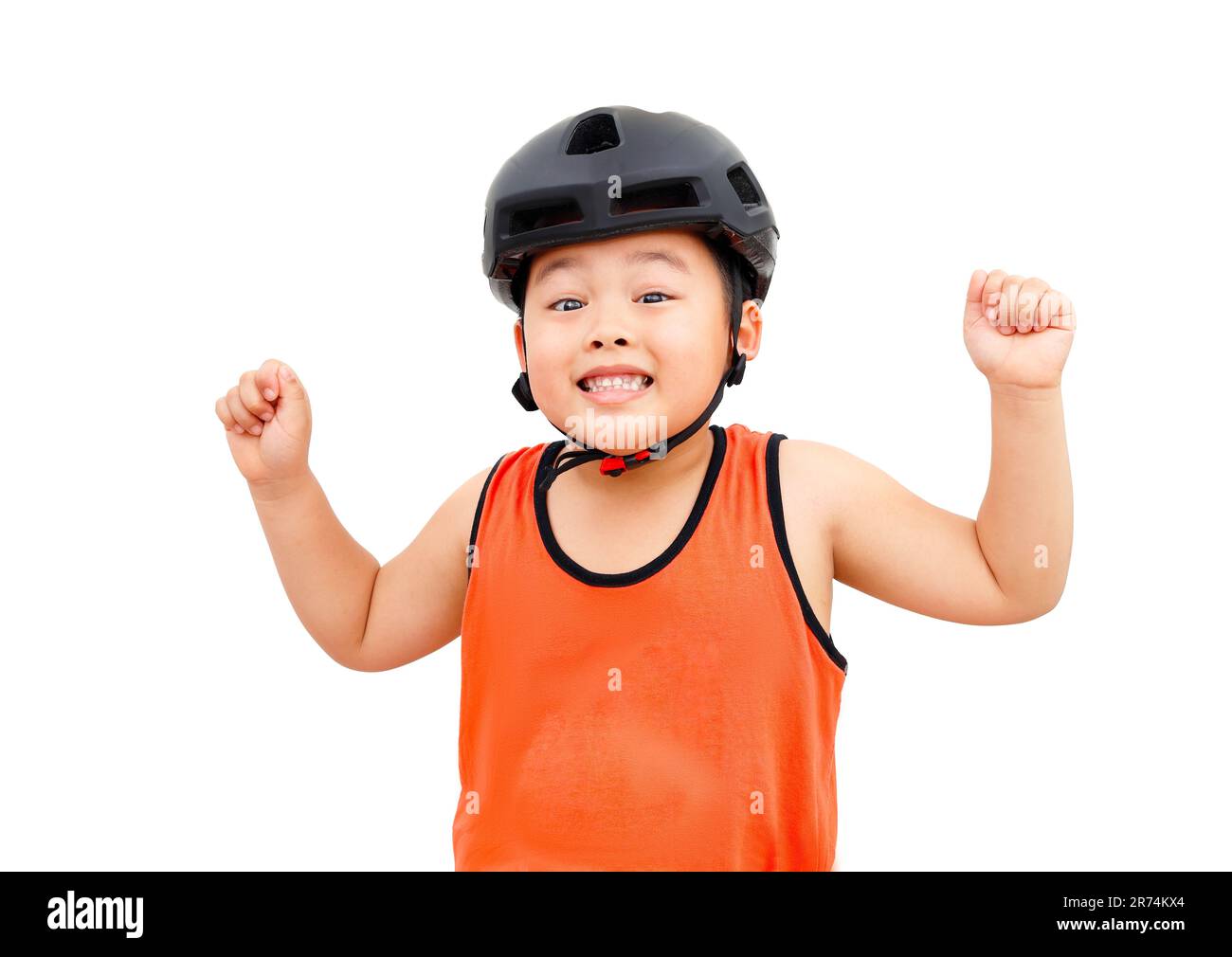 Little cute boy wearing bike helmet proud and very excited with raised arms. Isolated on white ...
