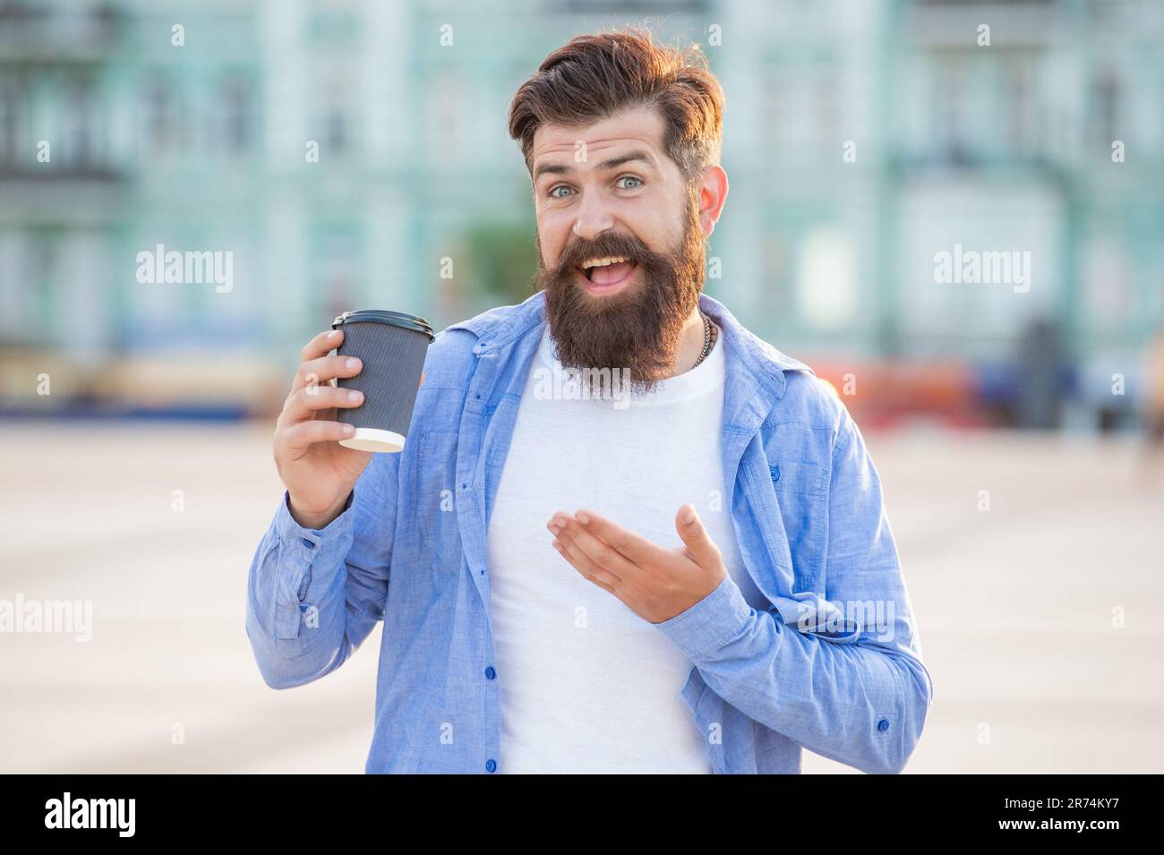 guy offering coffee outside, presenting. guy offering coffee in the ...