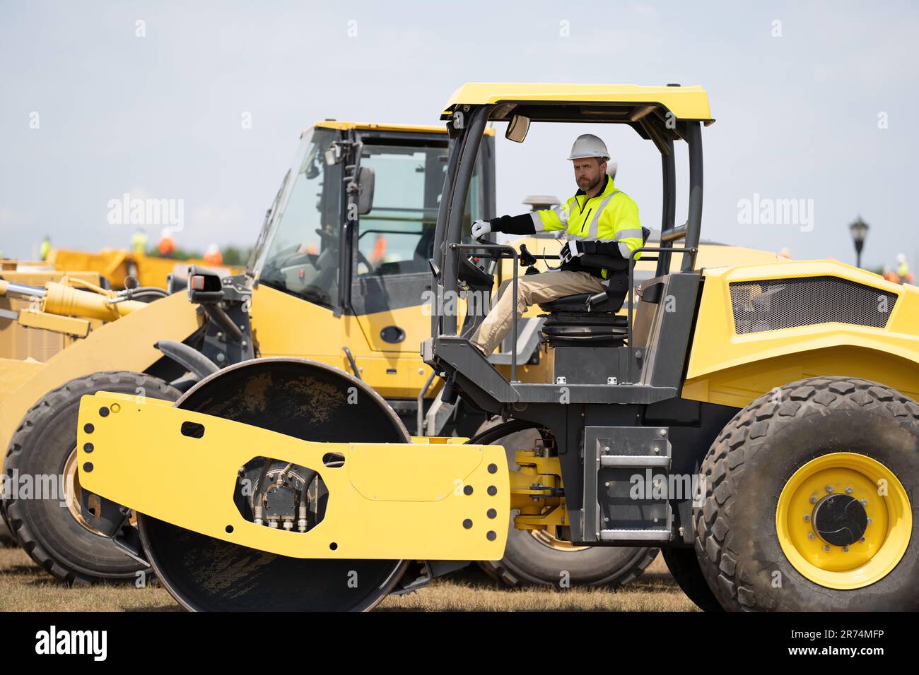 construction man worker at construction heavy machinery or roadwork ...