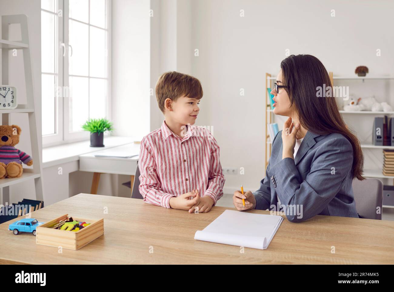 Little boy learning how to correctly articulate sounds with woman ...