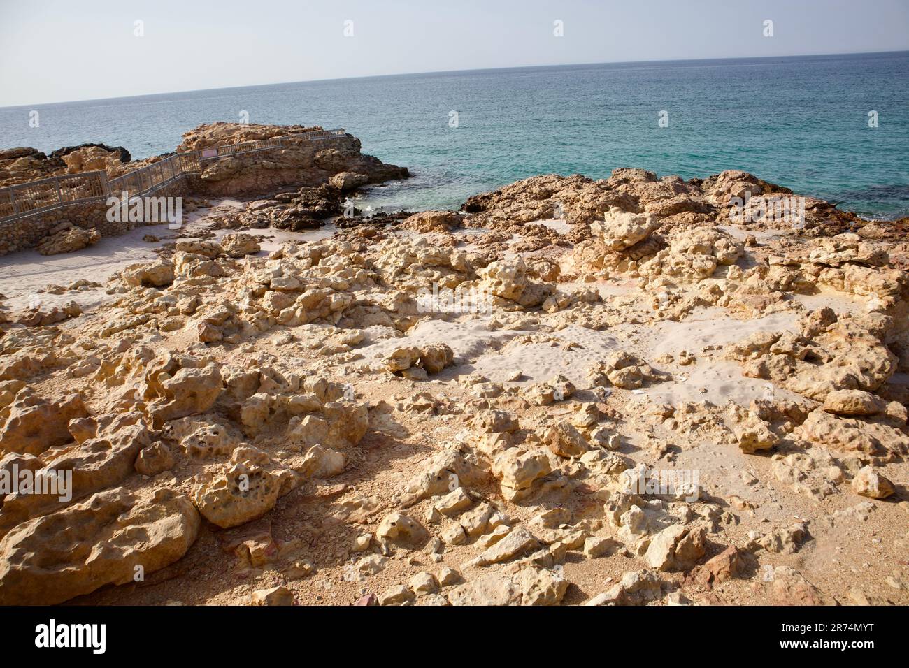 The Ras Al Hadd Beach in Oman with coral reefs and mountain rocks Stock ...