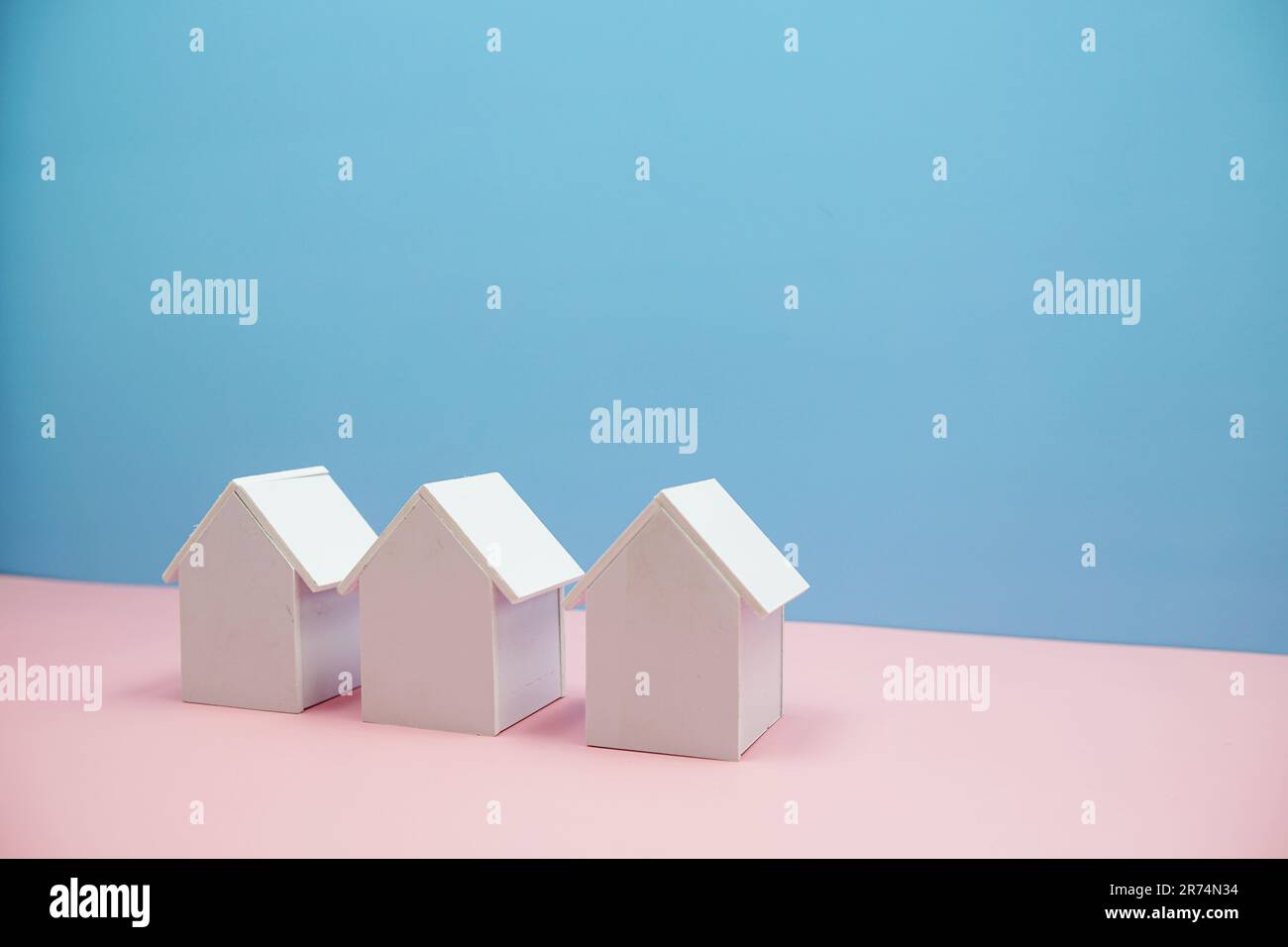 Group of House Model isolated with space for copy on blue and pink ...