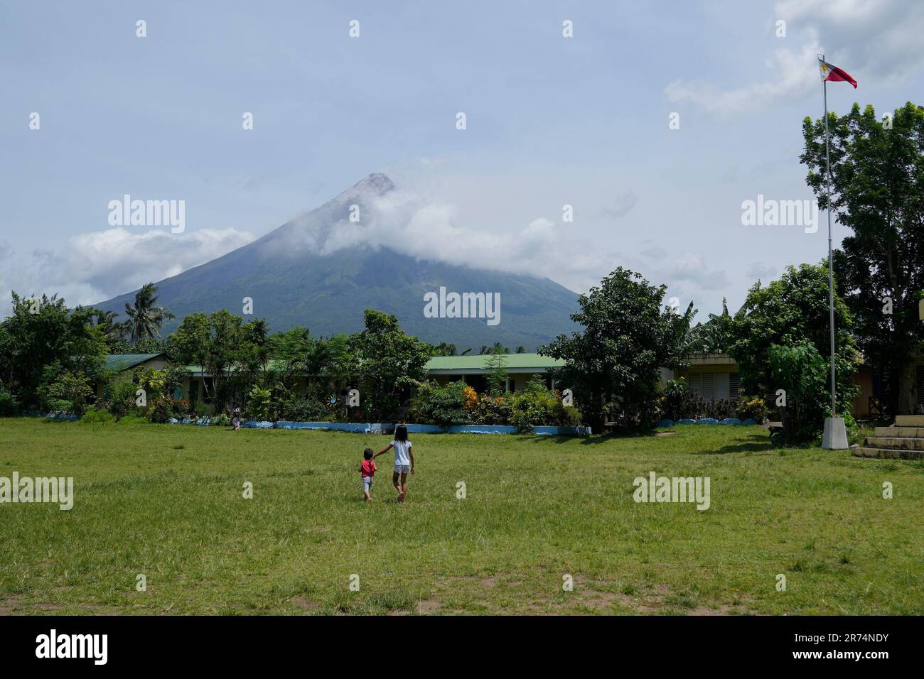 Mayon volcano is seen behind an evacuation center in Santo Domingo town ...