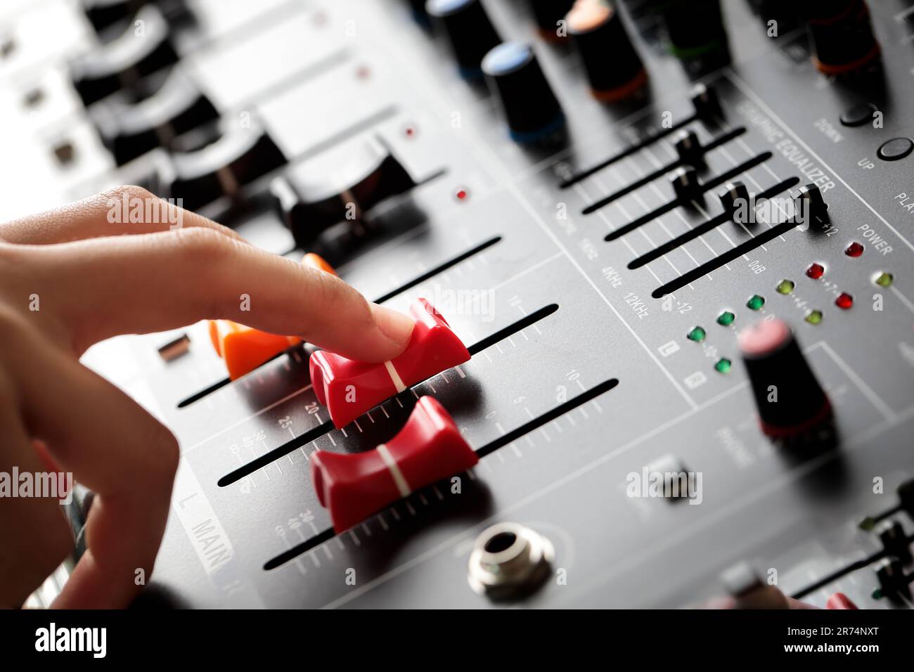 Female hand adjusting the volume in the sound mixer board Stock Photo ...