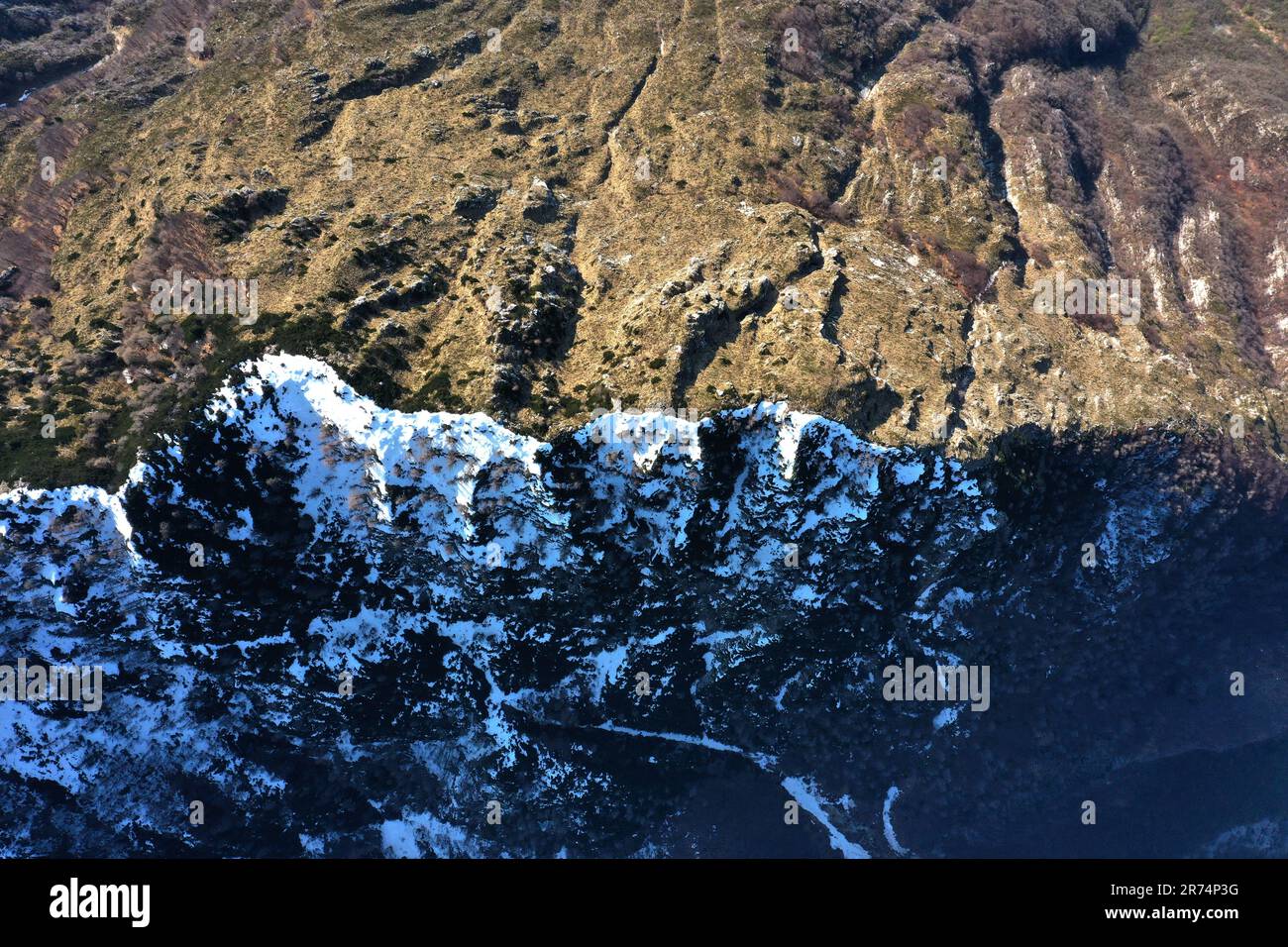 An aerial view of a majestic mountain range, captured from an elevated ...