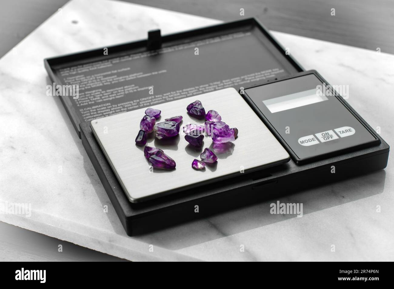 polished amethyst on a scale in a mineral shop, jewelry trade Stock ...