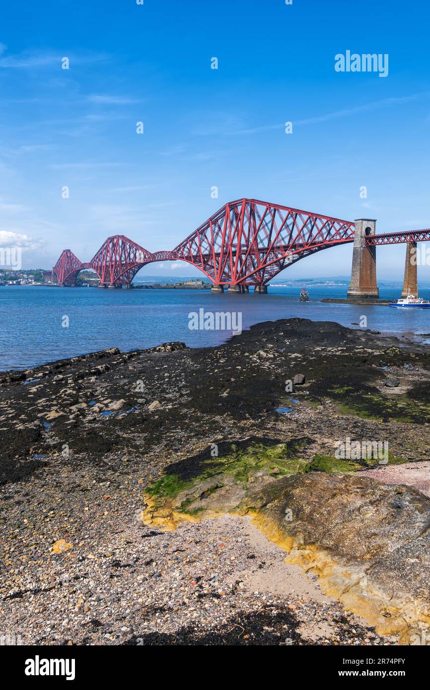 The Forth Bridge across Firth of Forth estuary from the shore in ...