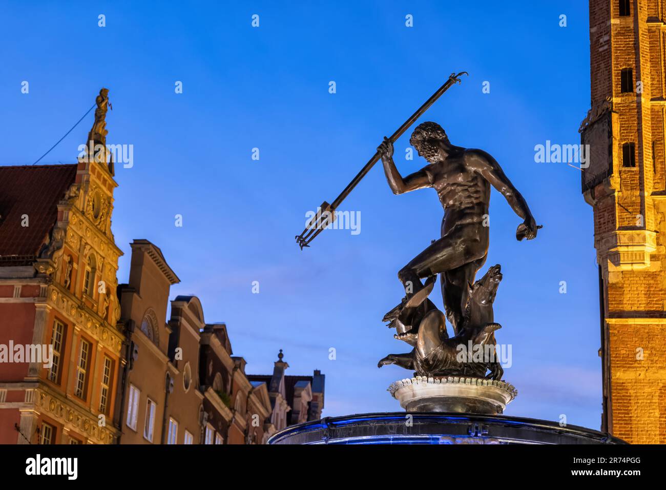 Evening at the Neptune Fountain statue in city of Gdansk in Poland ...