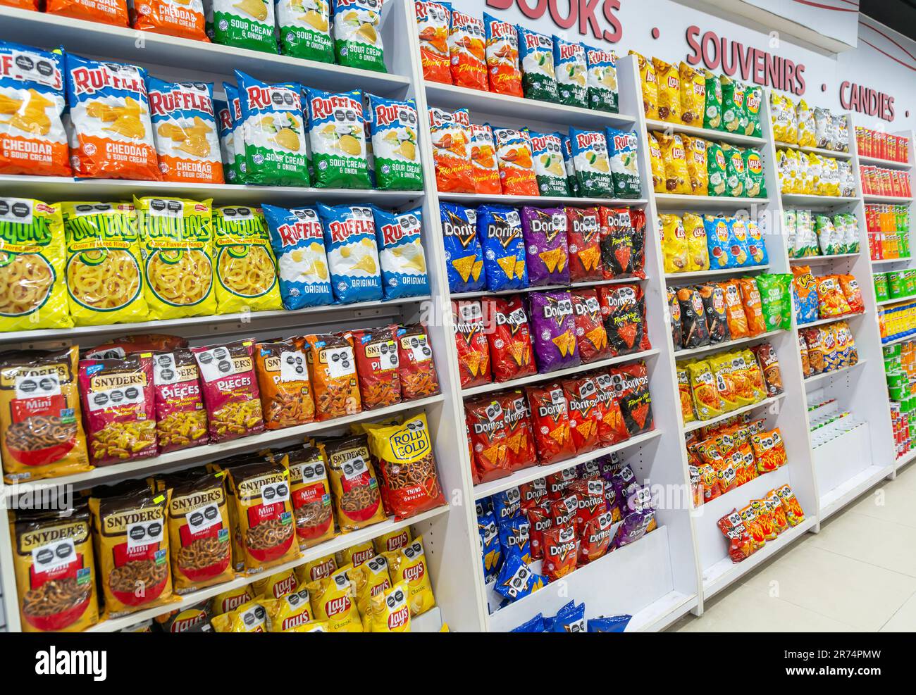 Display rows in shop of packets of crips, bags of chips, potato and ...