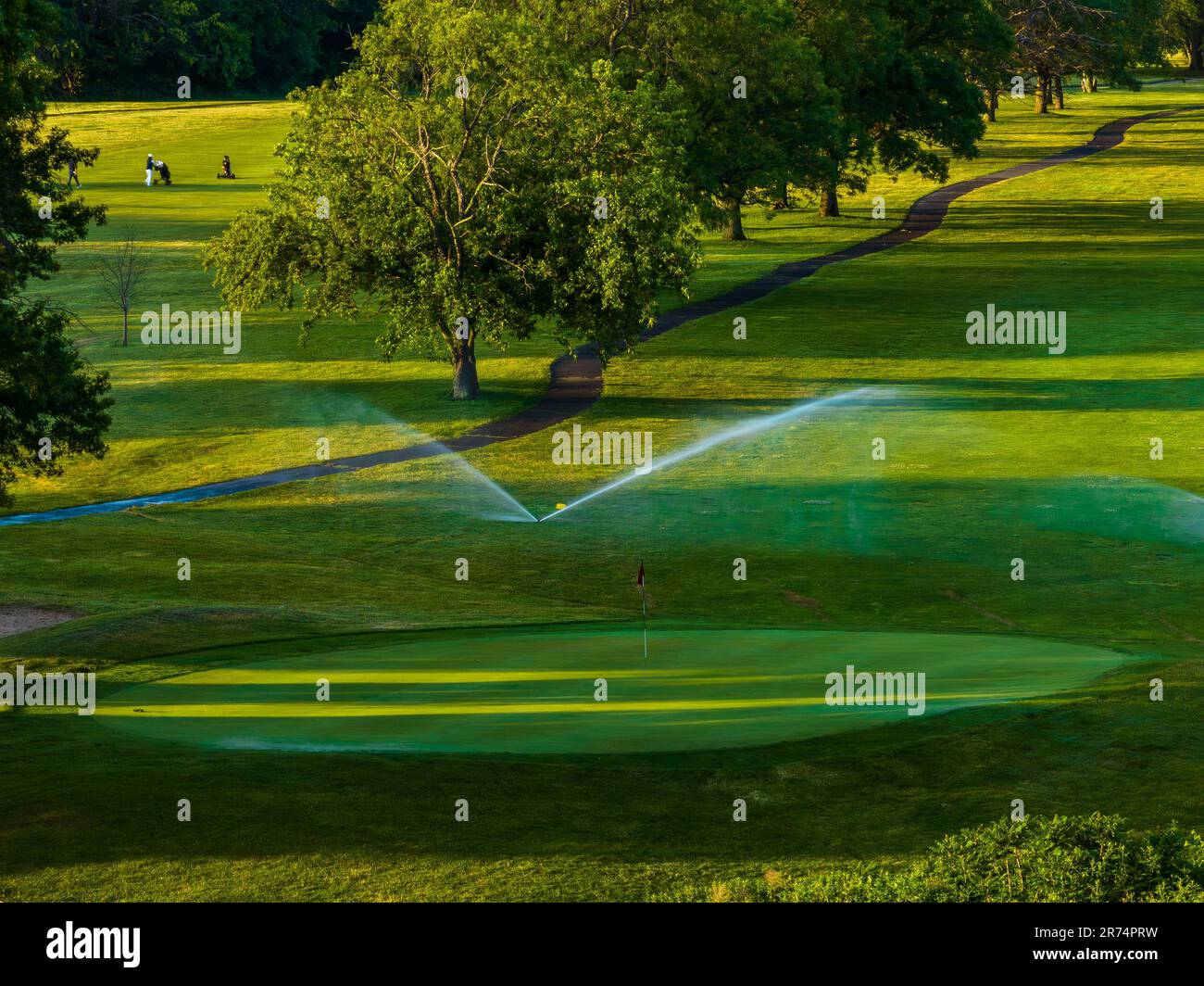 A golf course with a sprinkler Stock Photo - Alamy