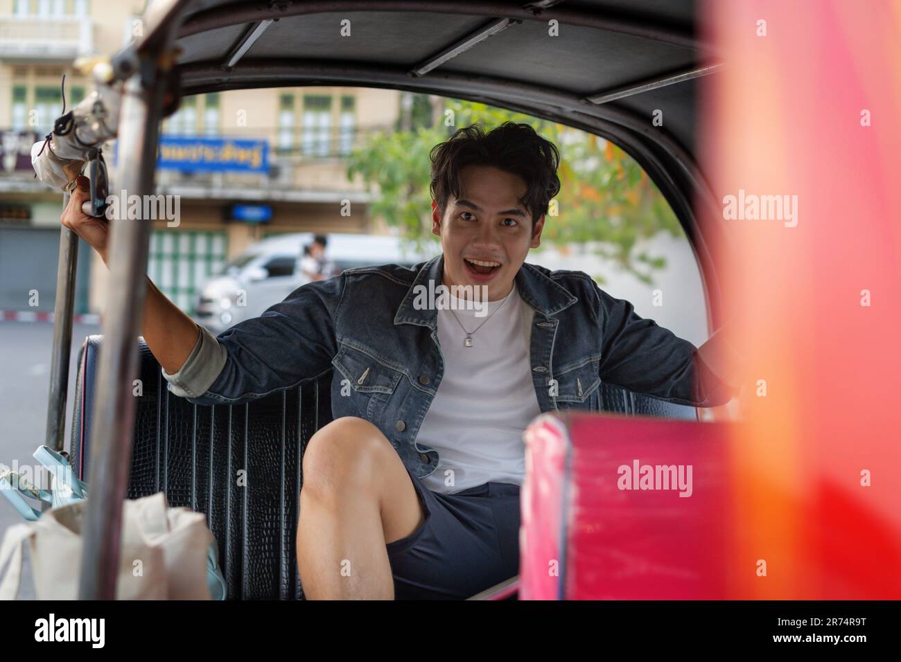 Happy and joyful Young Asian male traveler tourists riding a tuk tuk ...