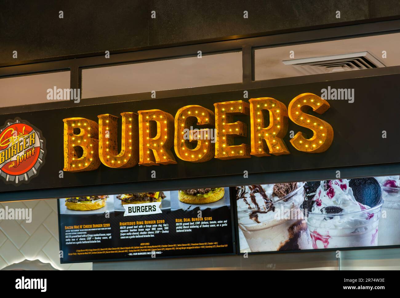 Burgers sign at Flavortown cafe restaurant bar, departure lounge area ...