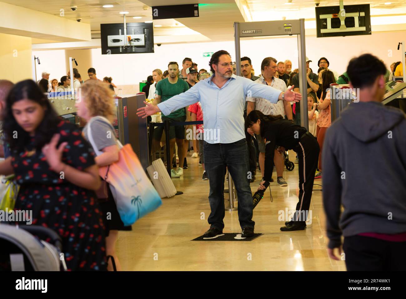 People passing through security check inside Cancun airport, Mexico man ...
