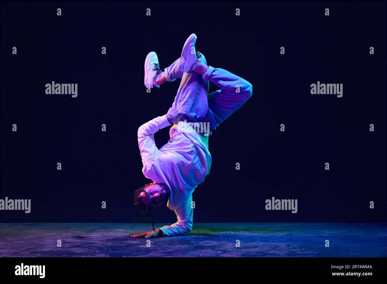 Trick. Artistic, sportive young man in sprotive clothes dancing ...