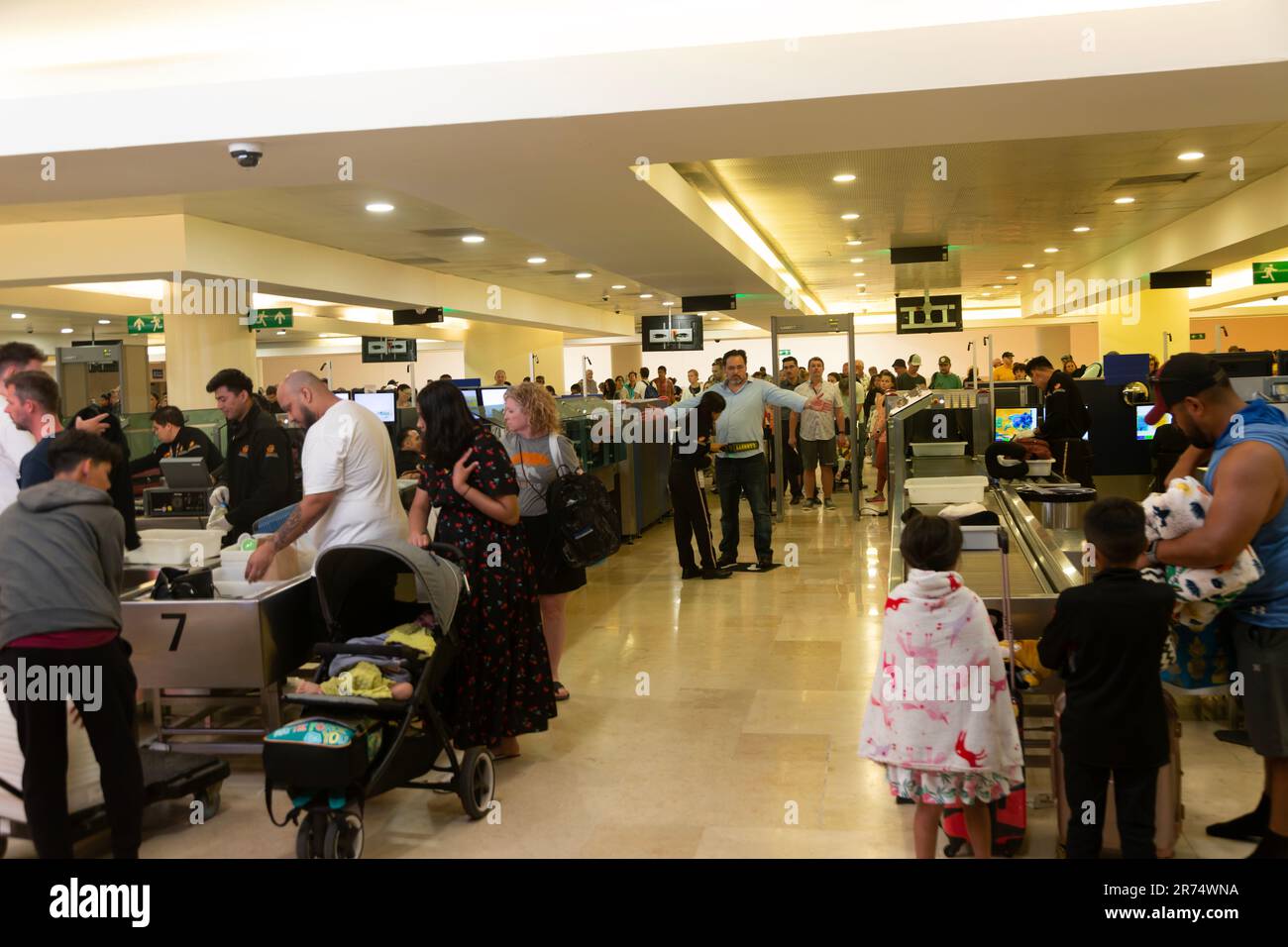 People passing through security check inside Cancun airport, Mexico ...