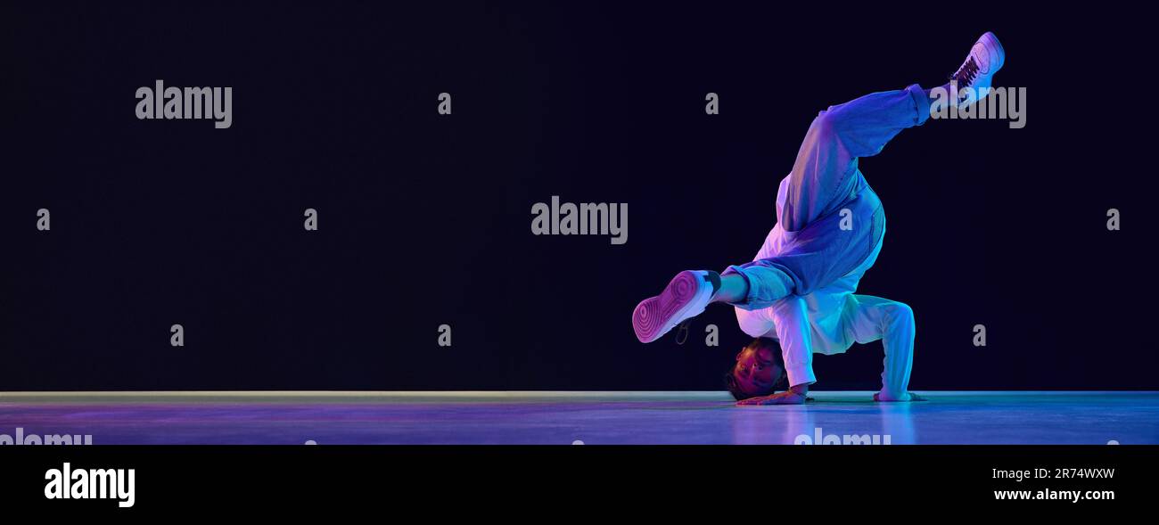 Young active man in casual clothes dancing hip-hop, breakdance against ...