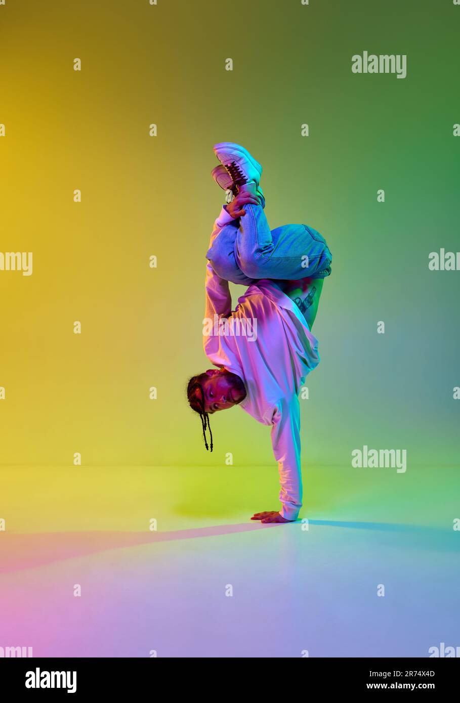 Young talented guy with dreads hairstyle dancing hip-hop, breakdance ...