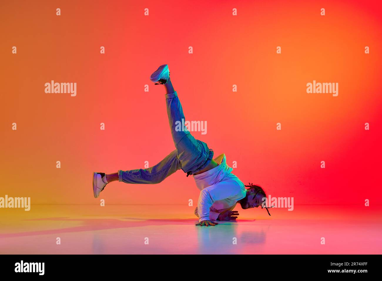 Dance show. Dynamic image of young guy dancing breakdance against ...