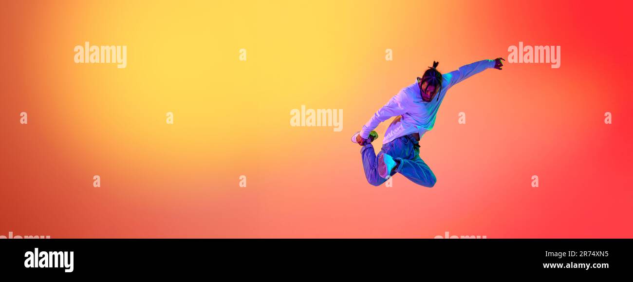 Standing on hands. Young guy making performance, dancing breakdance ...