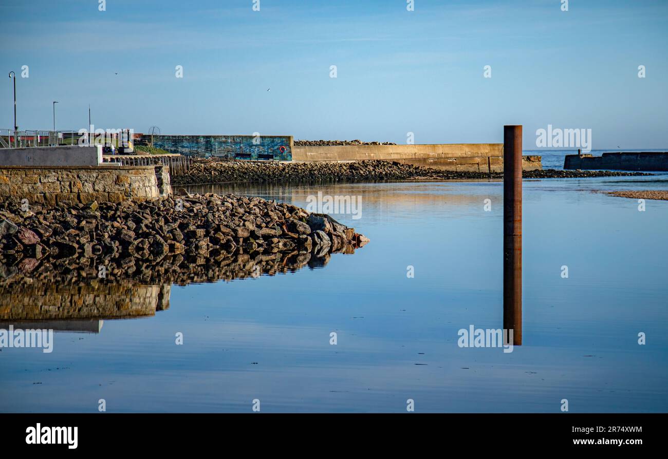 Posts in place with reflection in the water ready for the construction ...