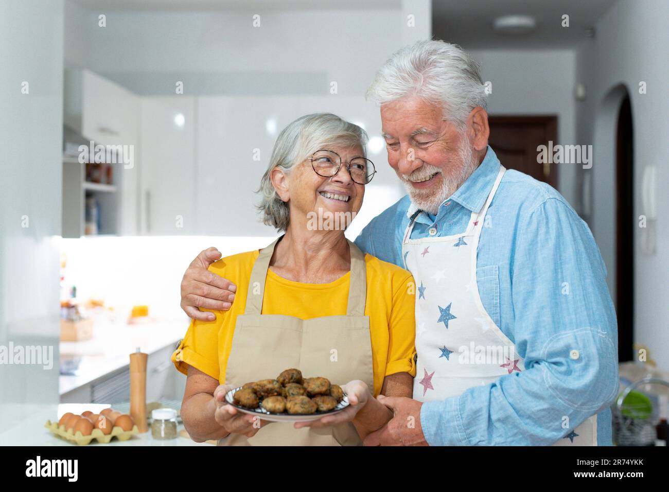 Headshot portrait of cute old couple of seniors showing to camera what ...