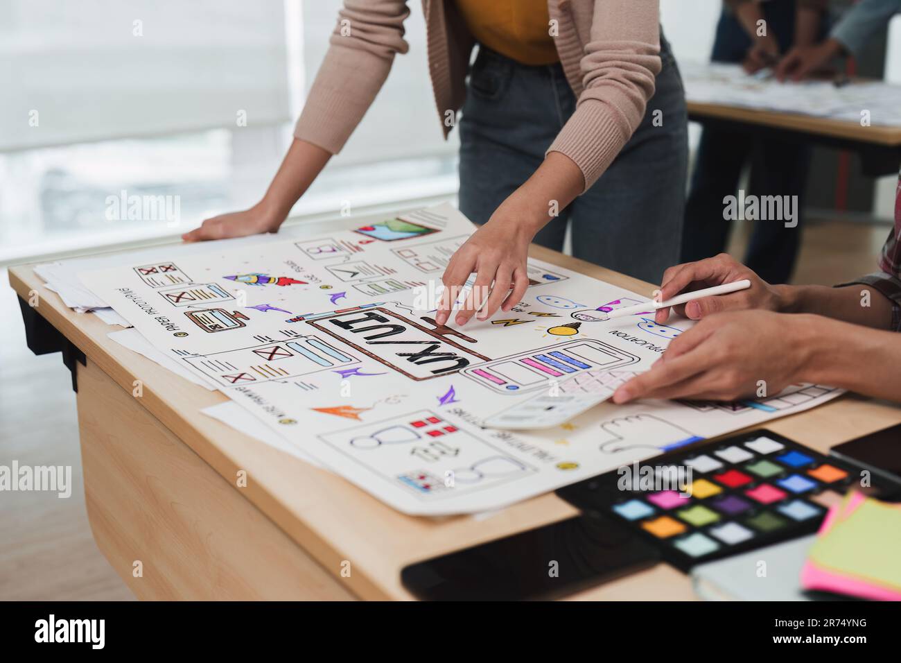 Close up ux developer and ui designer brainstorming interface wireframe ...