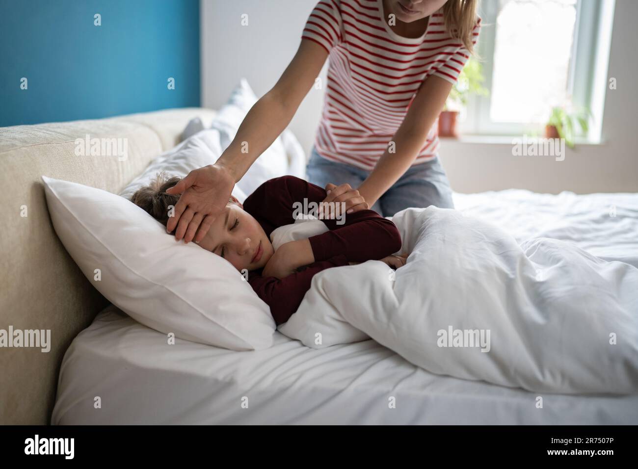 Sick little boy lying in bed, having chills and fever Stock Photo - Alamy