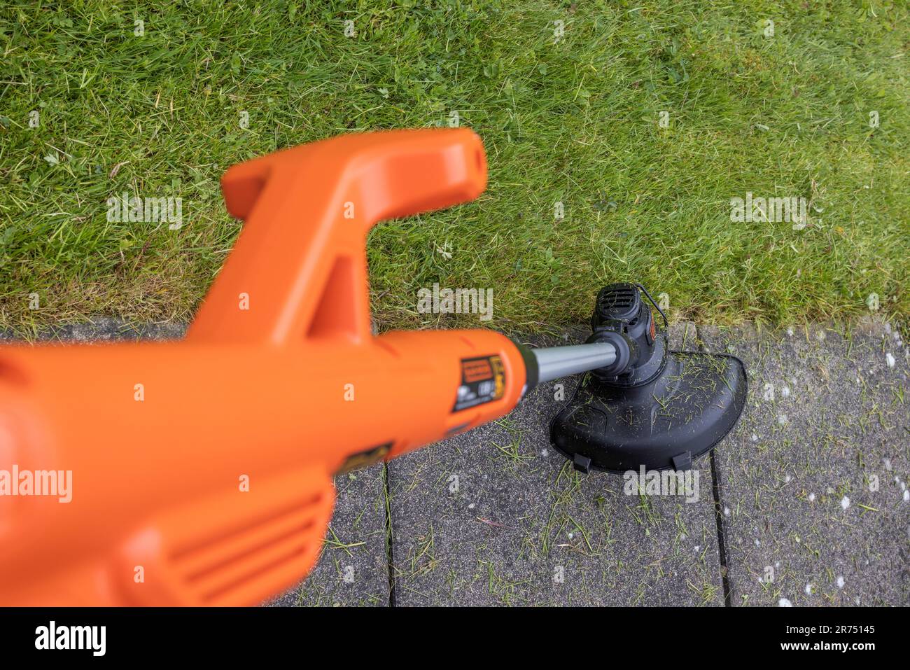 Cutting lawn edges with Black & Decker cordless lawn trimmer, lawn care ...