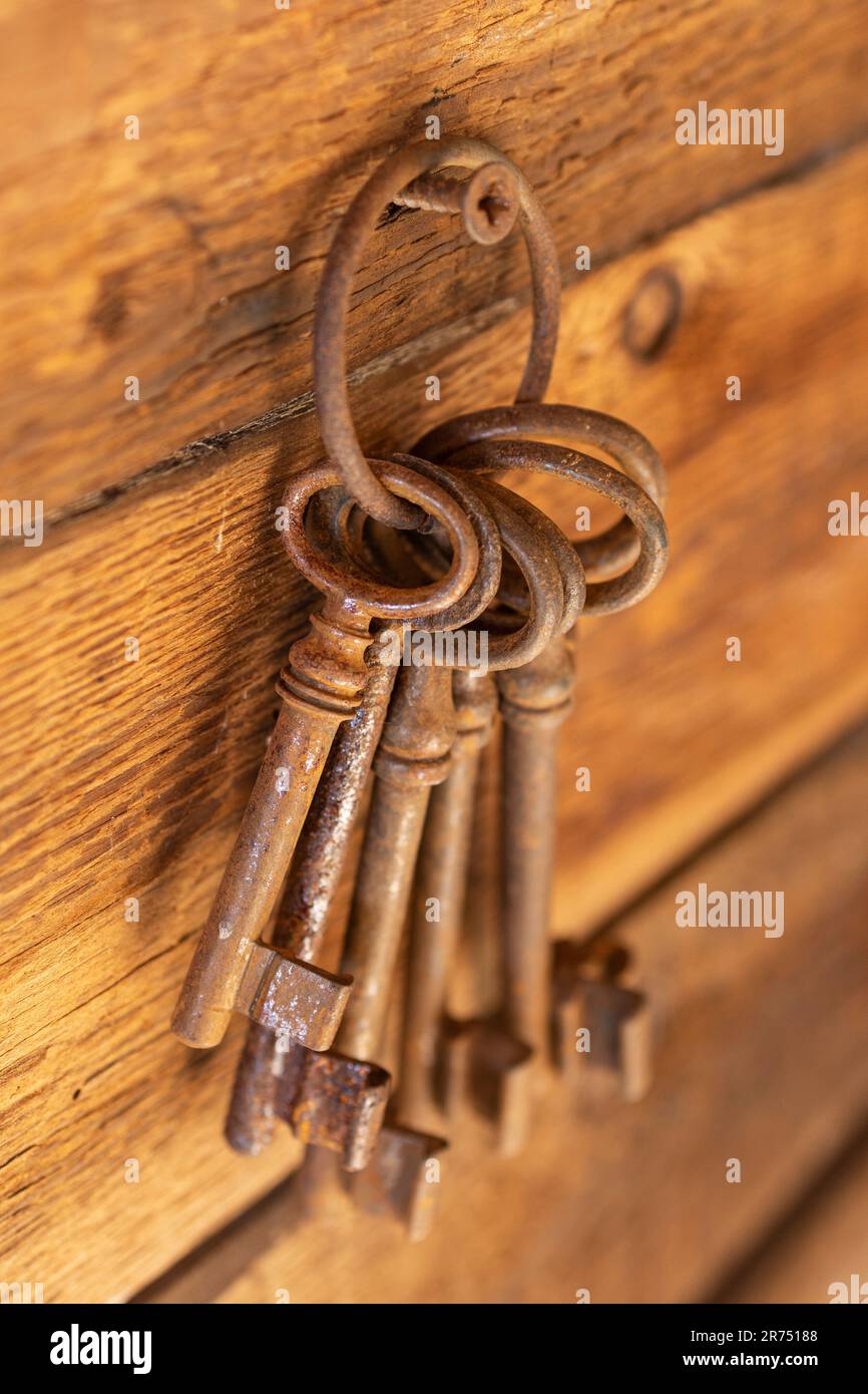 Old rusty key in the keyhole of a brown wooden door, blur Stock Photo ...
