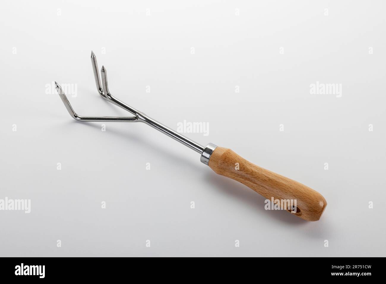 Hand hoe with wooden handle, white background Stock Photo - Alamy