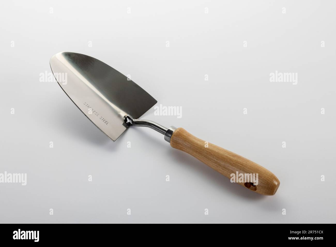 Flower trowel with wooden handle, white background Stock Photo - Alamy