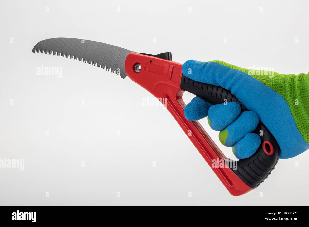 Hand with work glove holds small folding saw, white background Stock ...