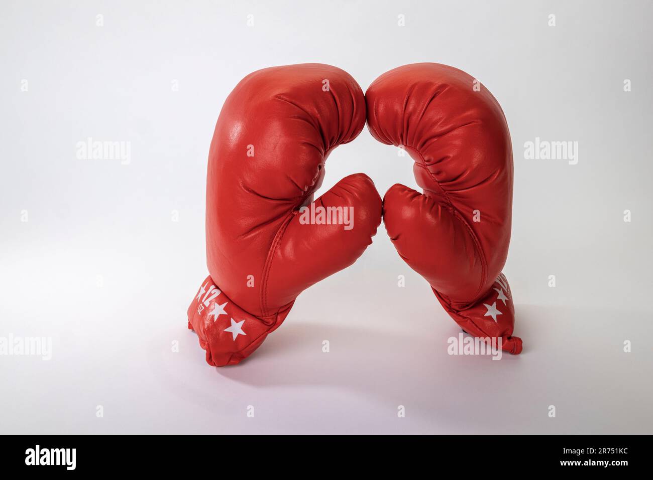 Pair of red boxing gloves, heart sign, white background Stock Photo - Alamy