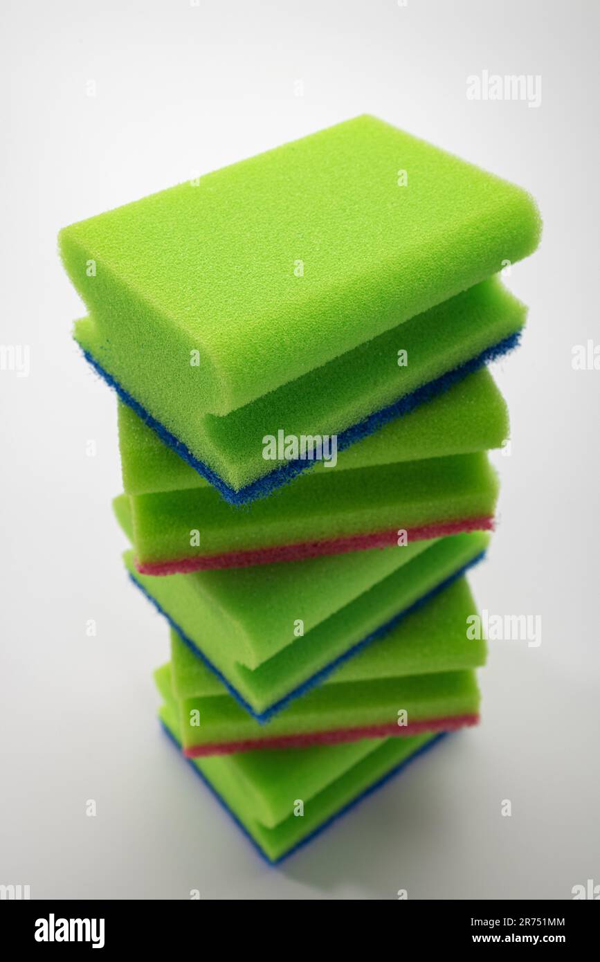 Stack of cleaning sponges with handle, white background Stock Photo - Alamy