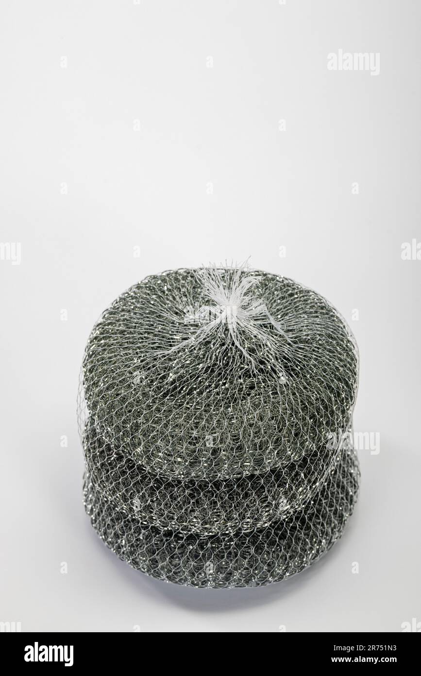 Three metal pot cleaner in net package, white background Stock Photo ...