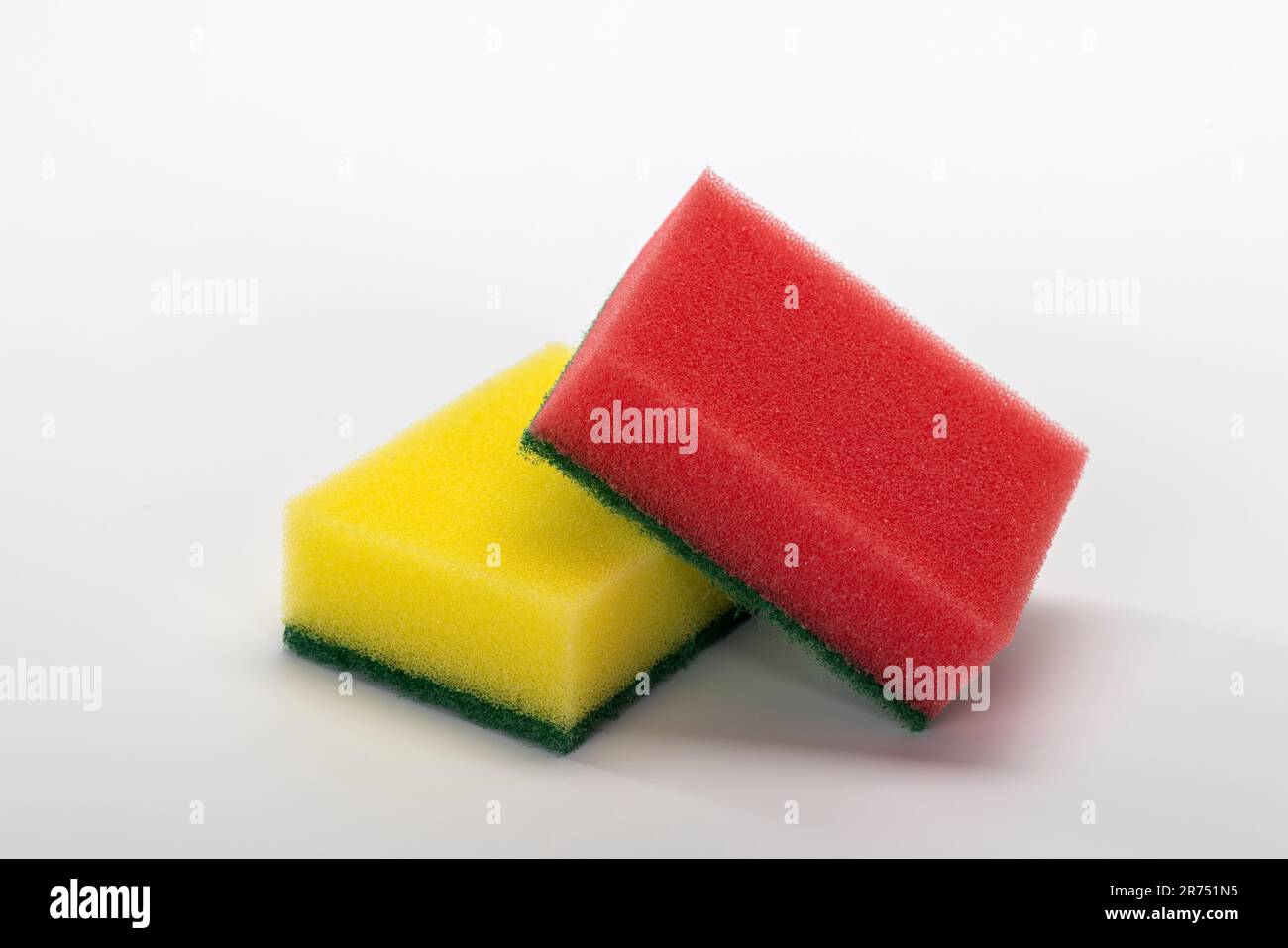 Two cleaning sponges yellow and red, white background Stock Photo - Alamy