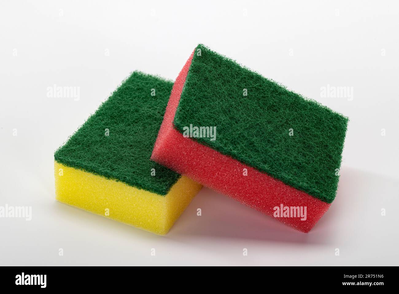 Two cleaning sponges yellow and red, white background Stock Photo - Alamy