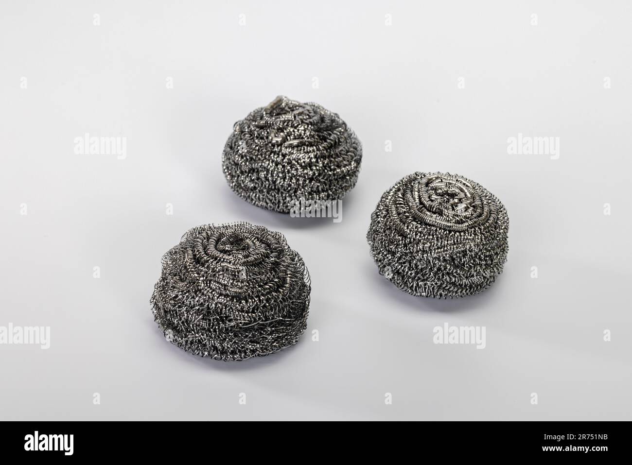 Three metal pot cleaner, stainless steel, white background Stock Photo ...