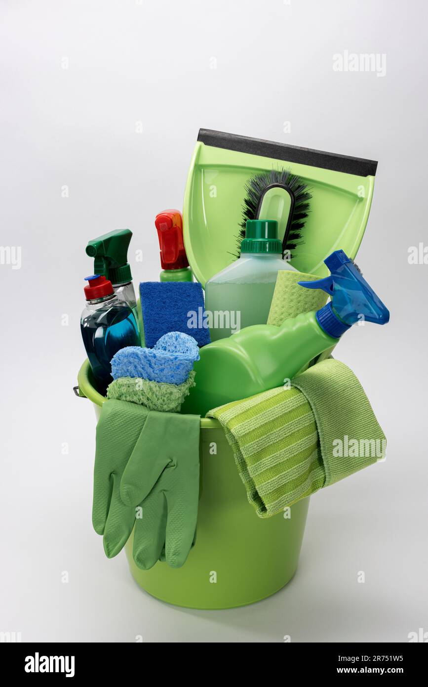 Green cleaning bucket filled with cleaning utensils, white background ...
