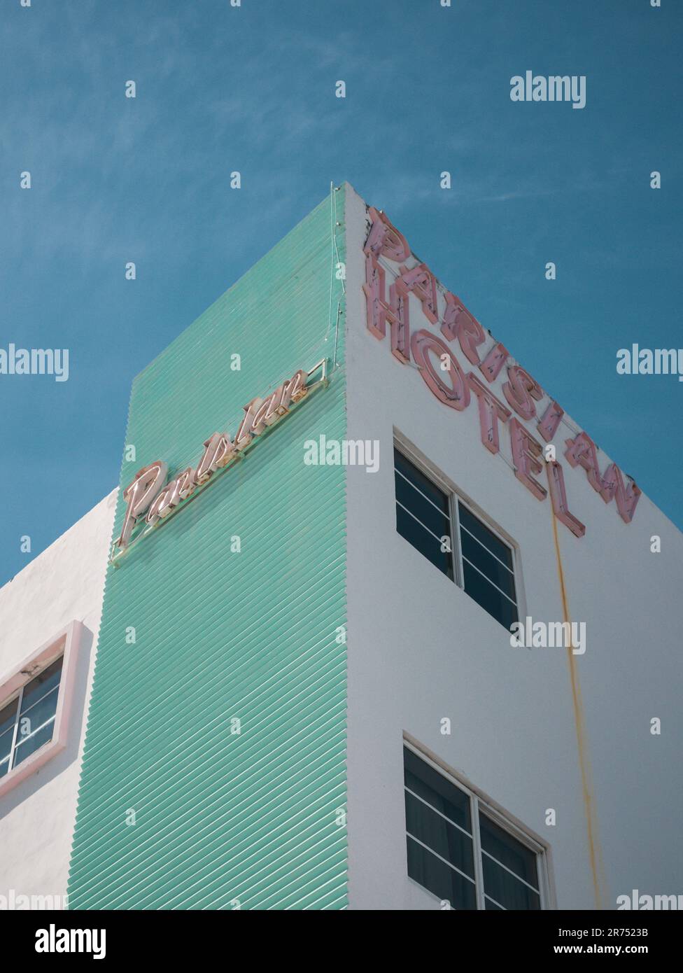 A vibrant high-rise building with an eye-catching neon sign making it ...