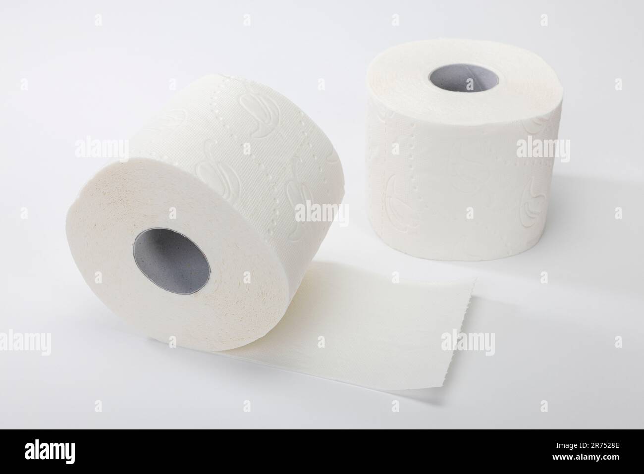 Two rolls of toilet paper, white background Stock Photo - Alamy