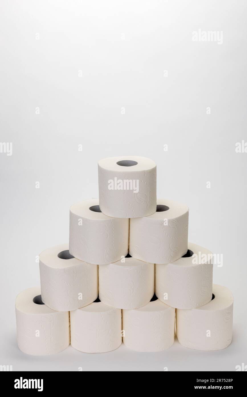 Many toilet paper rolls stacked as a pyramid, white background Stock ...