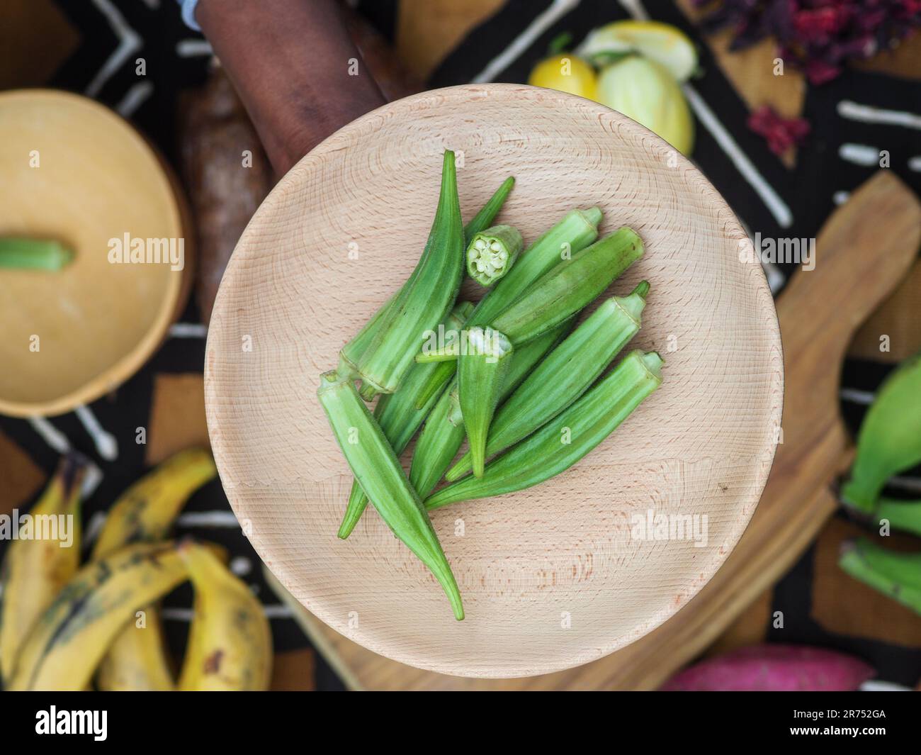 african woman chopping okra fruit veggies to cook traditional recipe ...