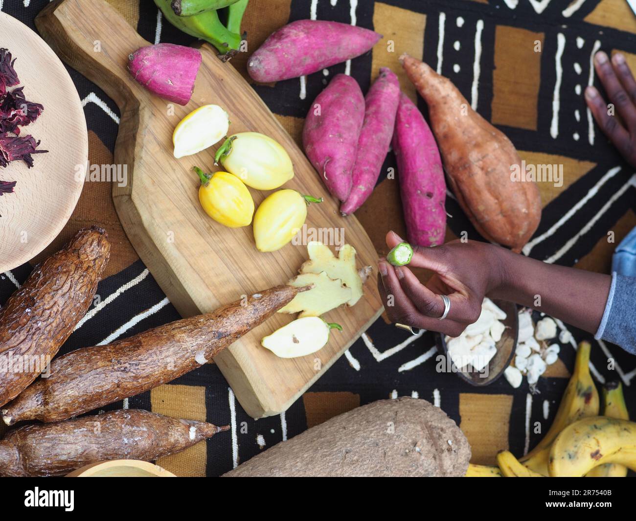 african woman chopping okra fruit veggies to cook traditional recipe ...