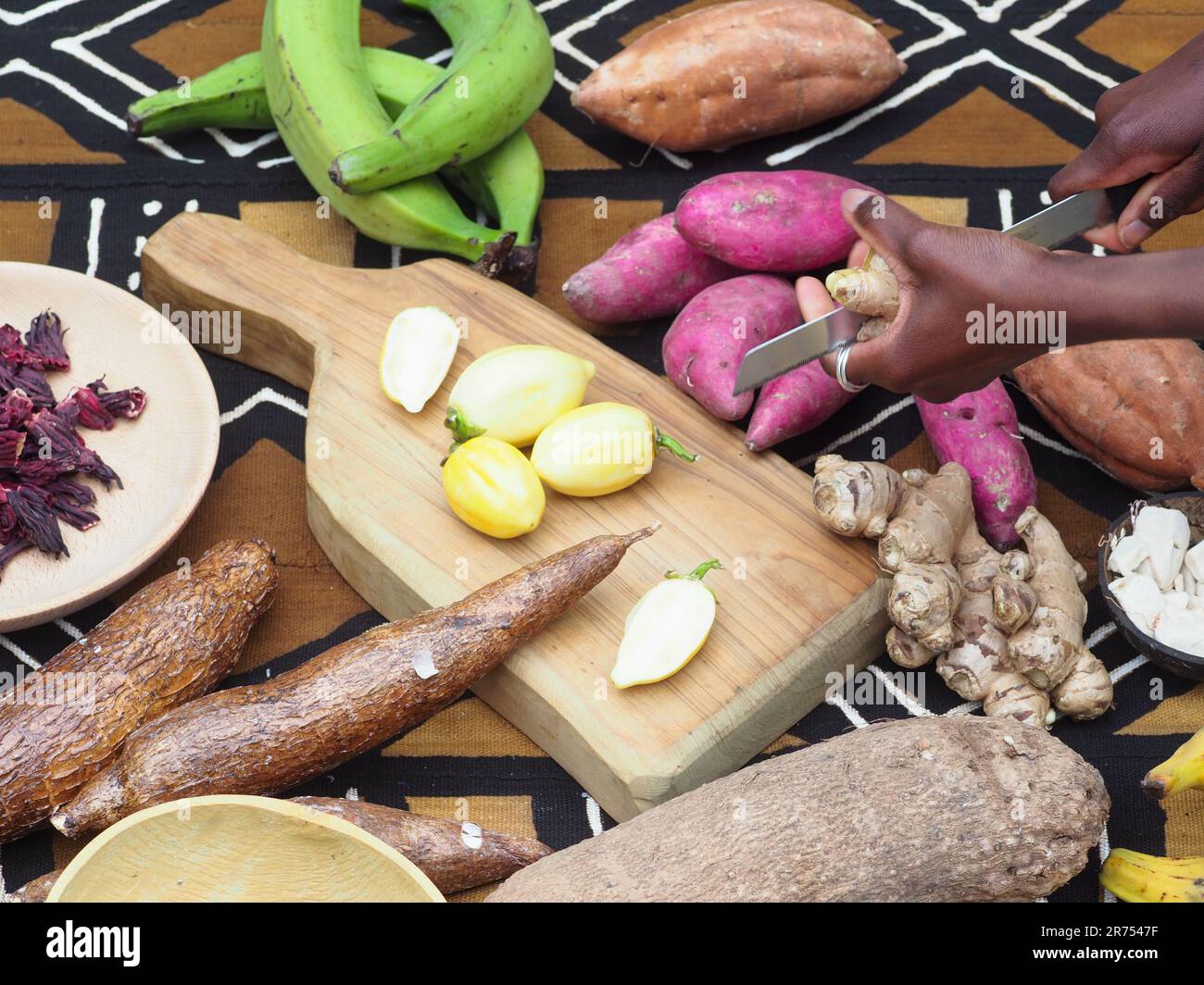 black woman cutting typical african veggies and fruits, overhead shot ...