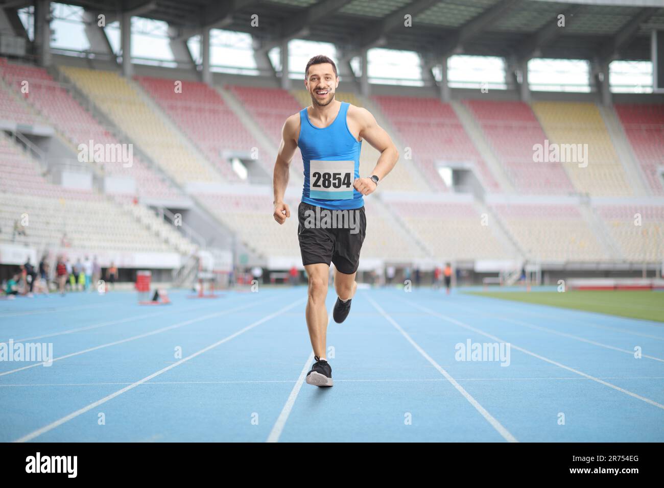 Full length portrait of a man running a race at a stadium Stock Photo ...