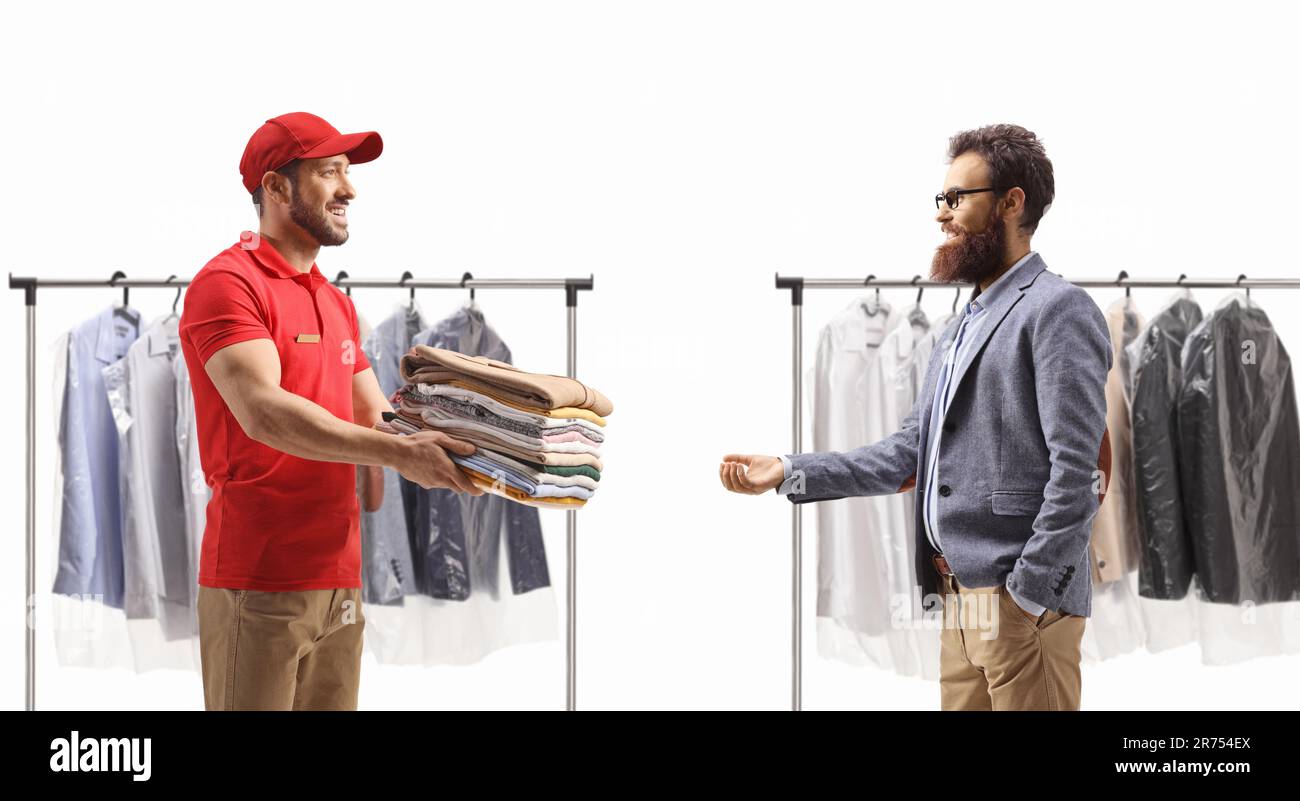 Man giving a pile of dry cleaning clothes to a male customer isolated ...