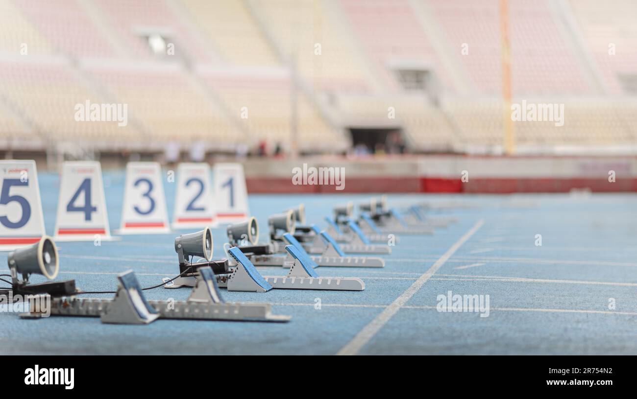 Athletics starting blocks on a blue running track at a stadium Stock ...