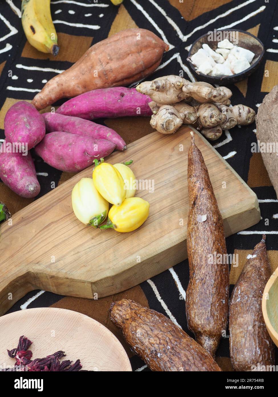 black woman cutting typical african veggies and fruits, overhead shot ...