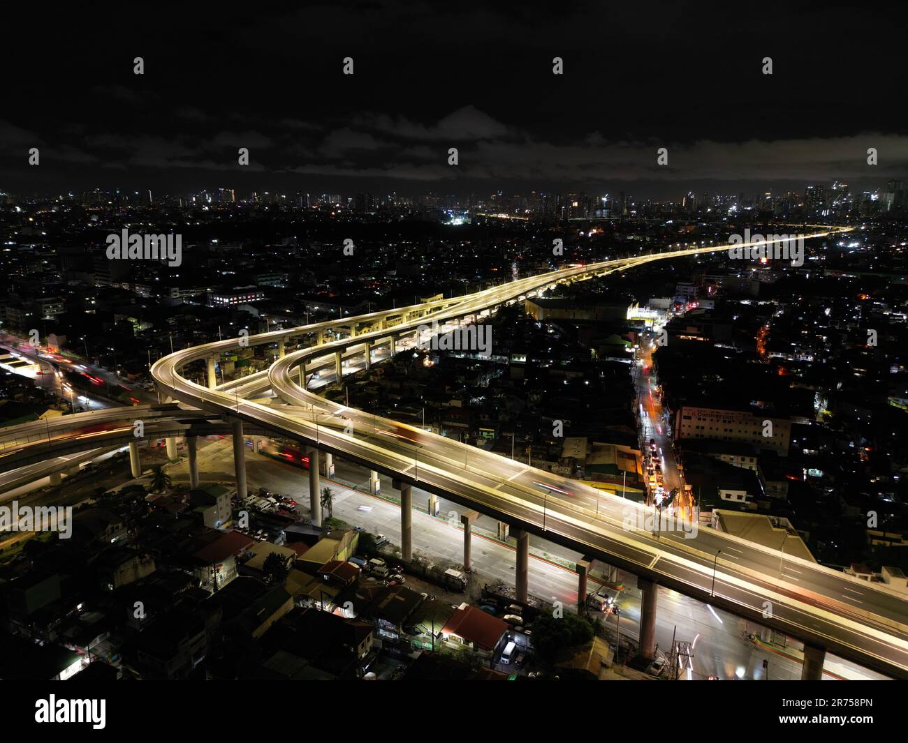 An aerial shot of a major highway and freeway junction at night ...